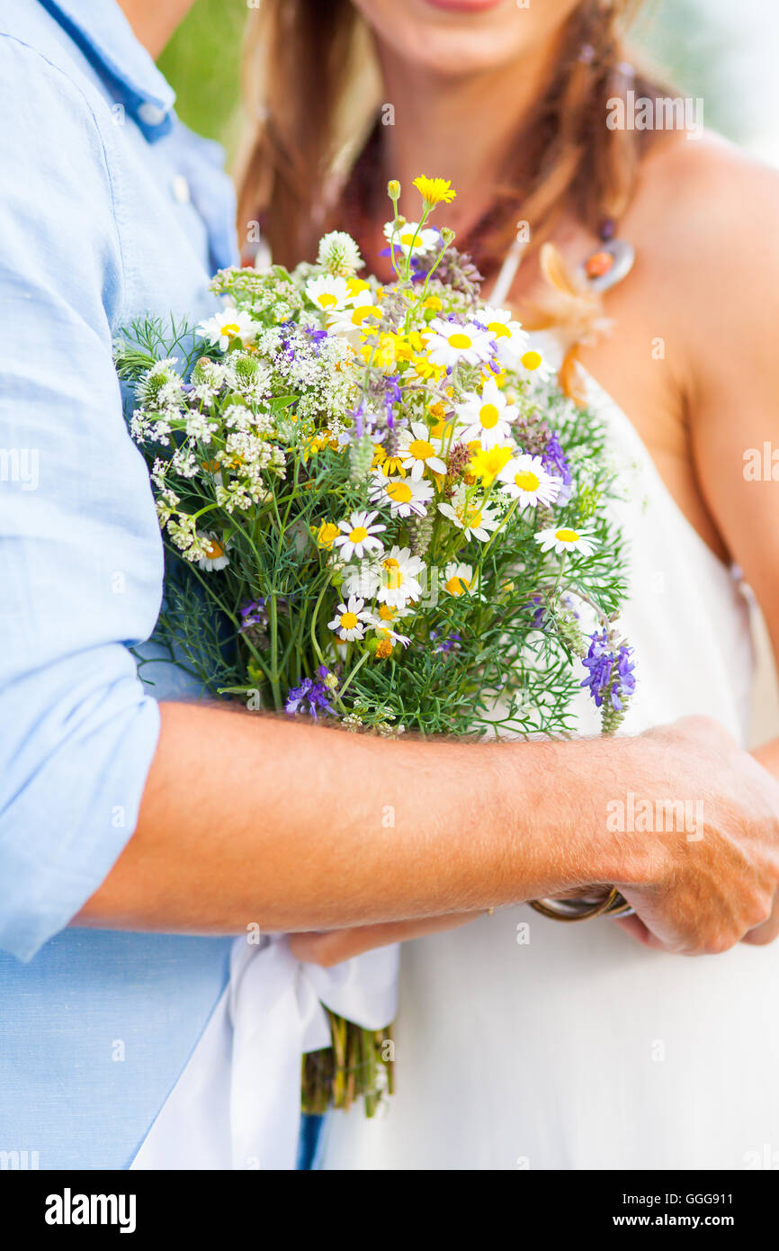 The crop image of romantic couple with flowers Stock Photo - Alamy