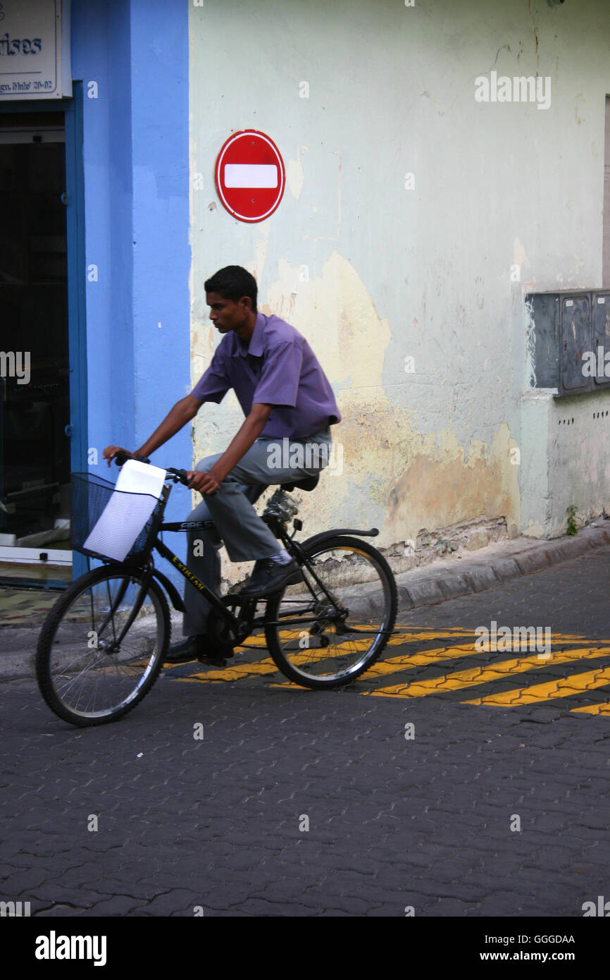 Traffic signs in maldives and man on bike Stock Photo - Alamy