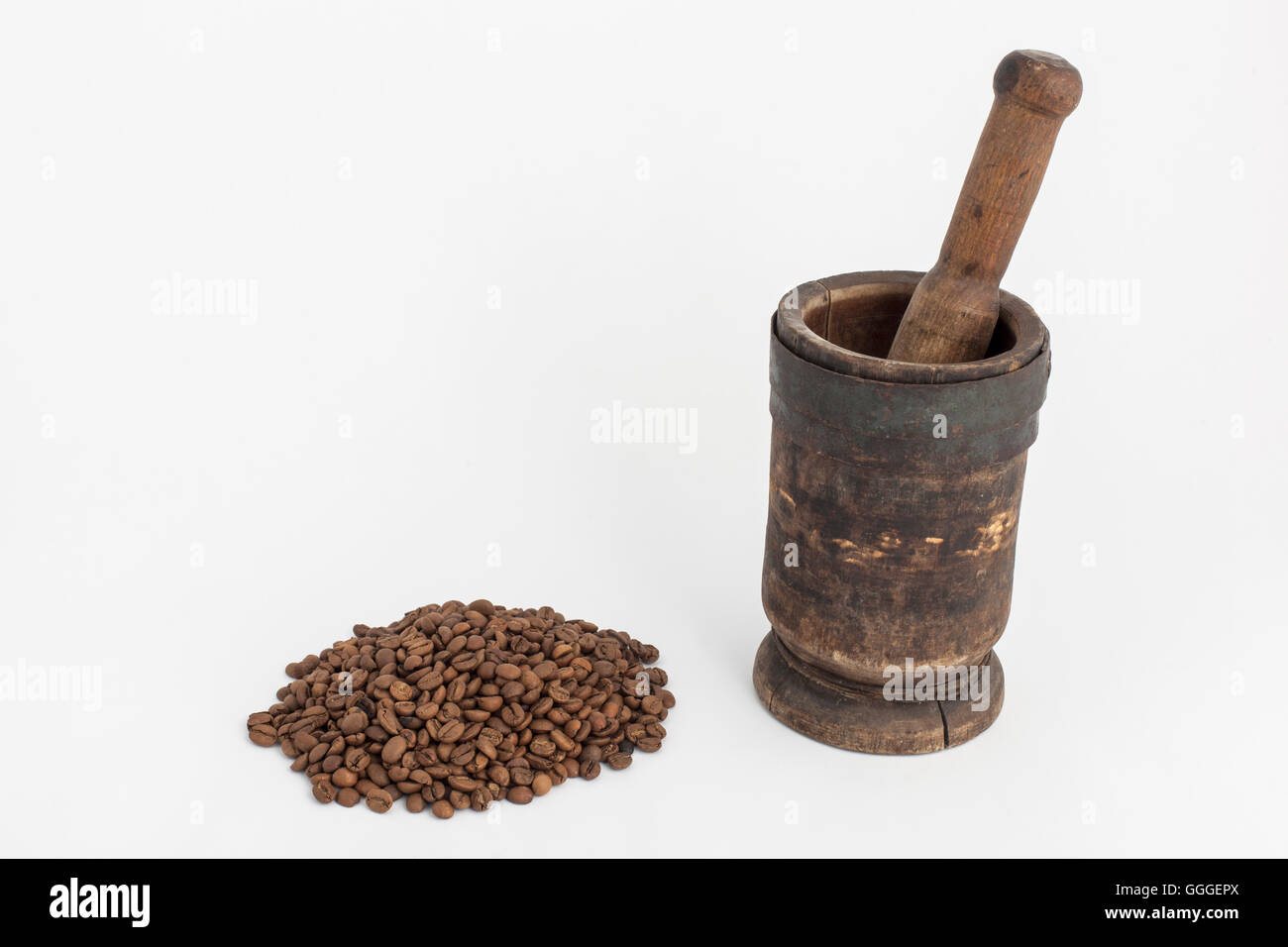 Mortar and pestle with coffee seeds closeup in studio on white ...