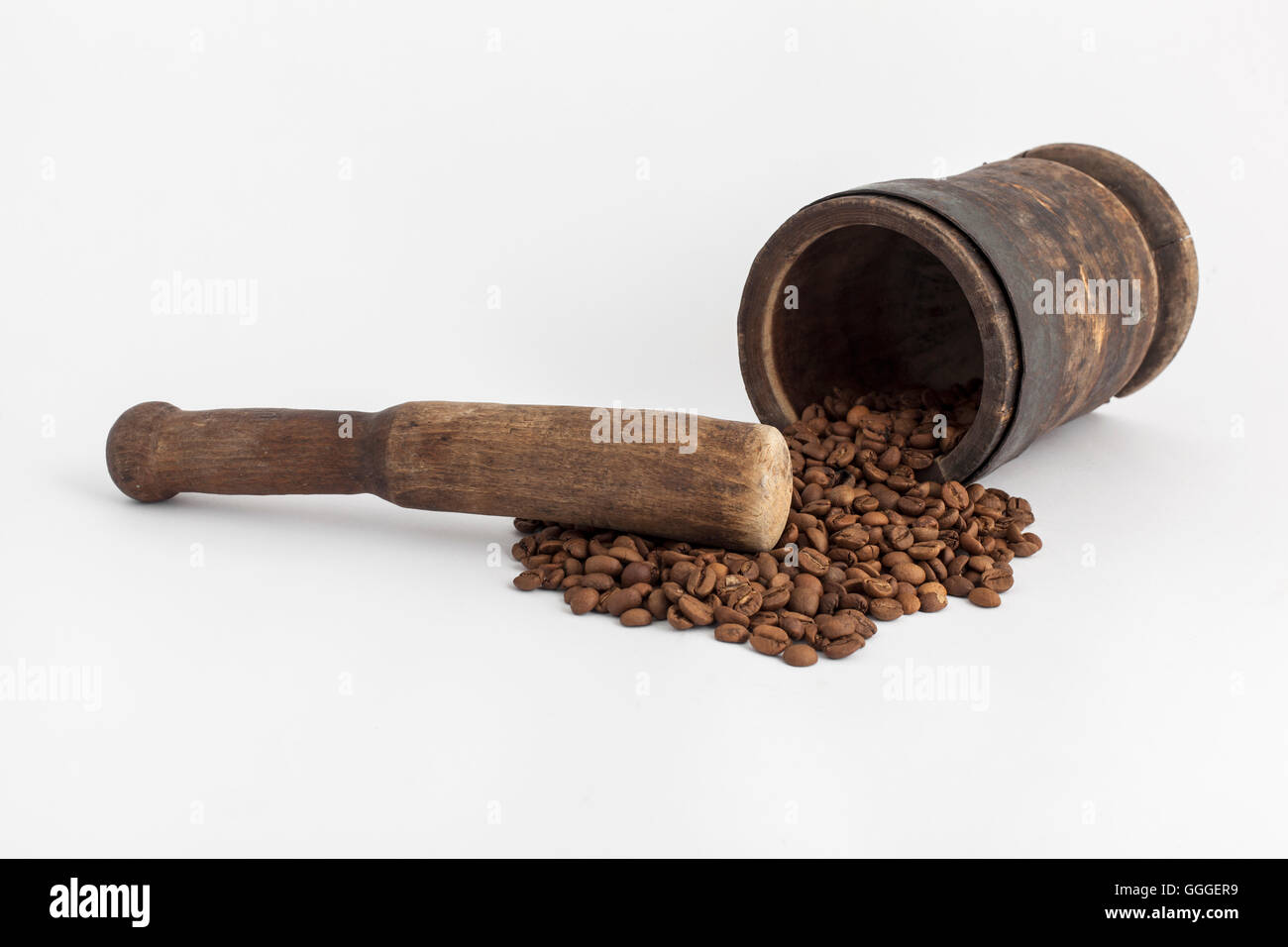 Mortar and pestle with coffee seeds closeup in studio on white ...