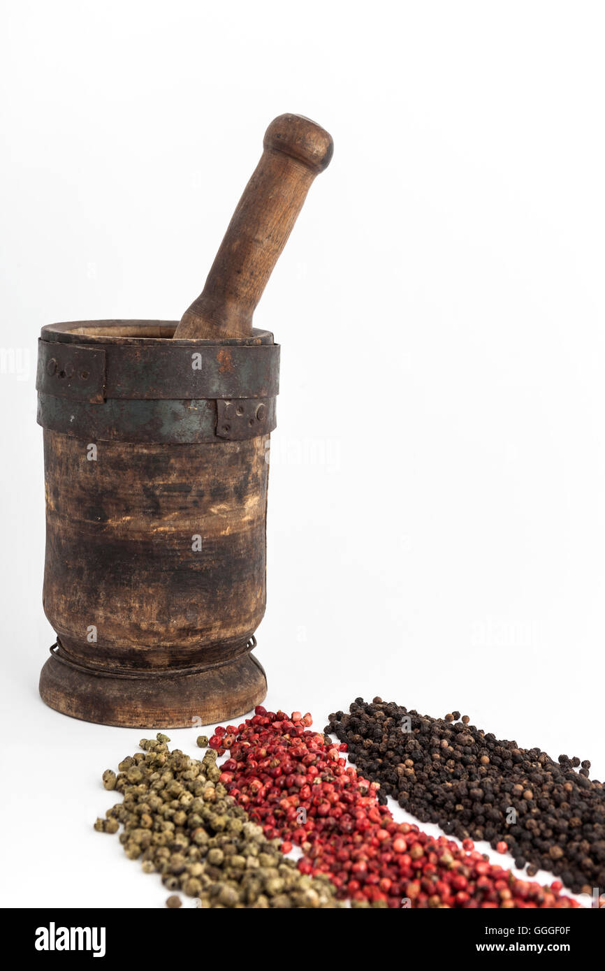 Mortar and pestle with pepper seeds closeup in studio on white ...