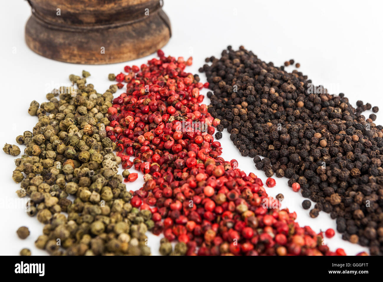 Mortar and pestle with pepper seeds closeup in studio on white ...