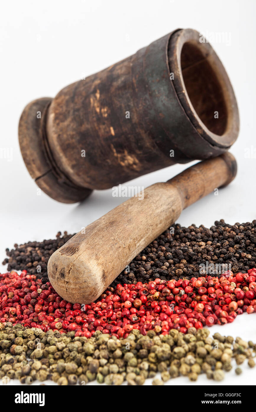Mortar and pestle with pepper seeds closeup in studio on white ...
