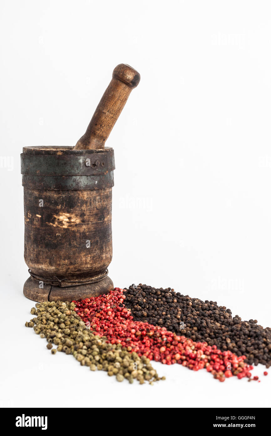 Mortar and pestle with pepper seeds closeup in studio on white ...