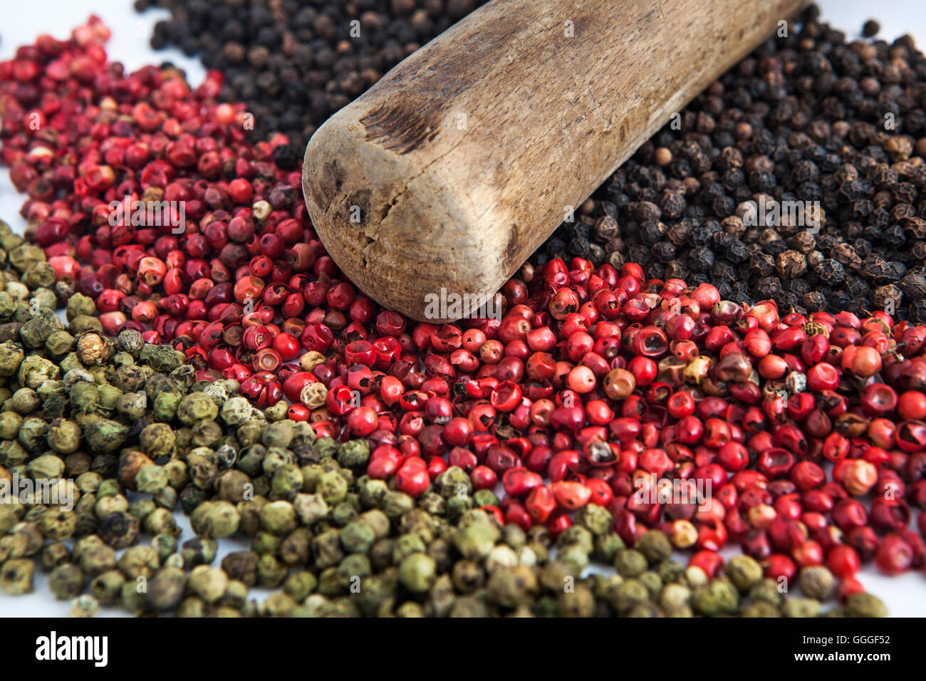 Mortar and pestle with pepper seeds closeup in studio on white ...