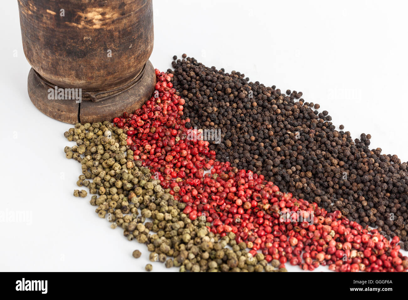 Mortar and pestle with pepper seeds closeup in studio on white ...