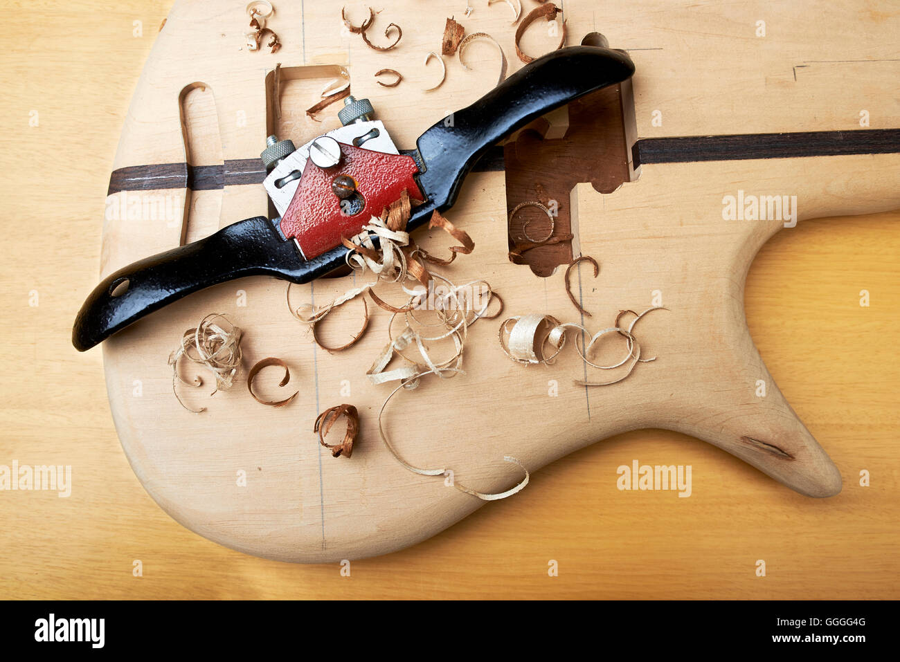 Bass guitar under construction, with tools and accessories Stock Photo ...