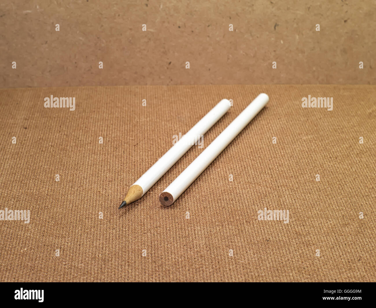 two white pencils with one pencil unsharpened and one pencil sharpened ...