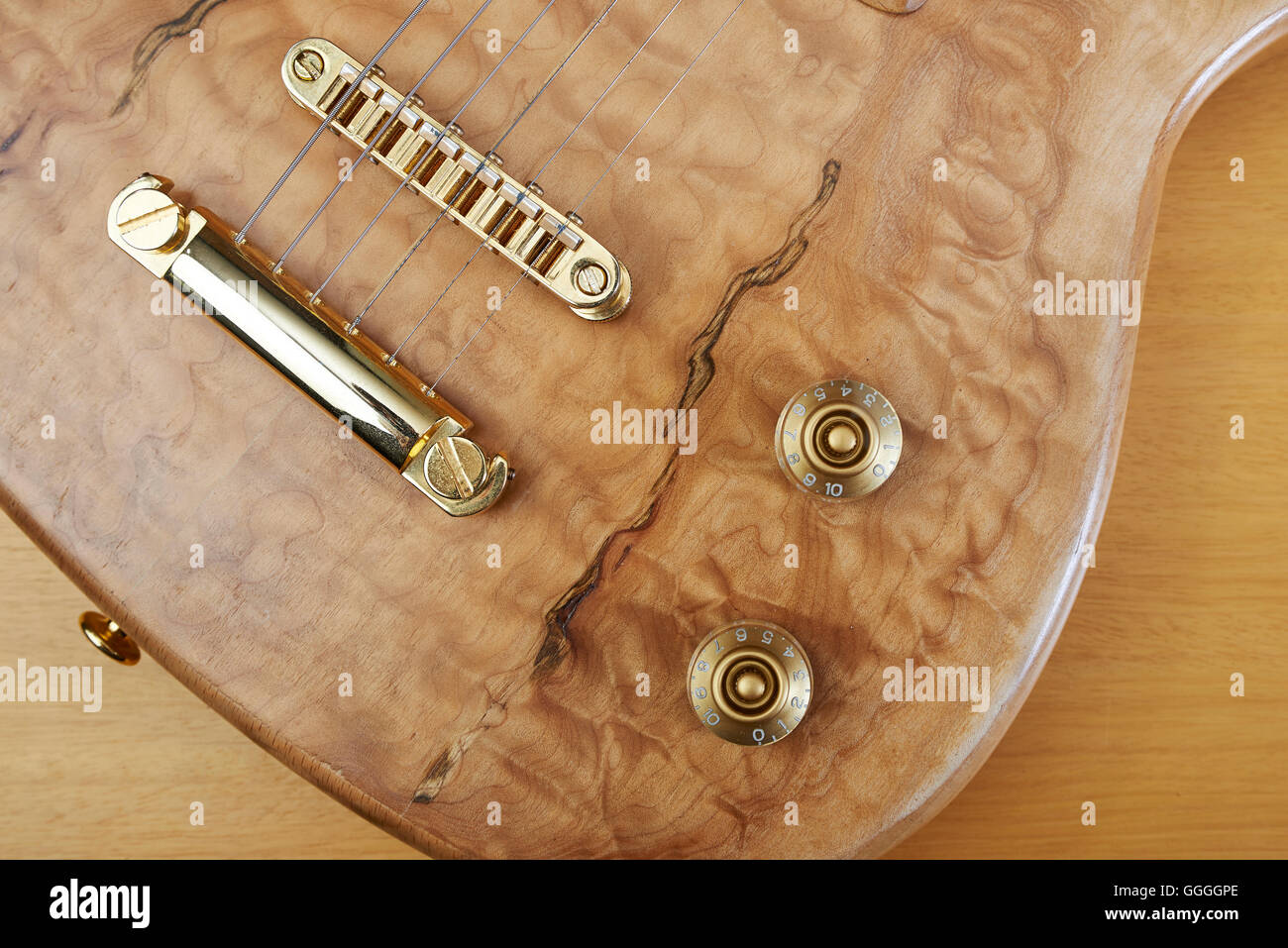 Guitar, wooden natural color with golden accessories Stock Photo - Alamy
