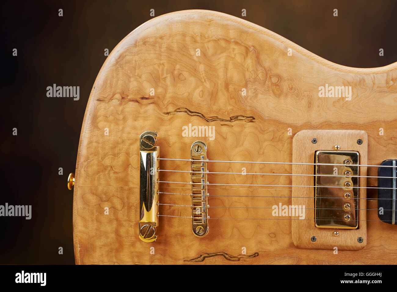 Guitar, wooden natural color with golden accessories Stock Photo - Alamy