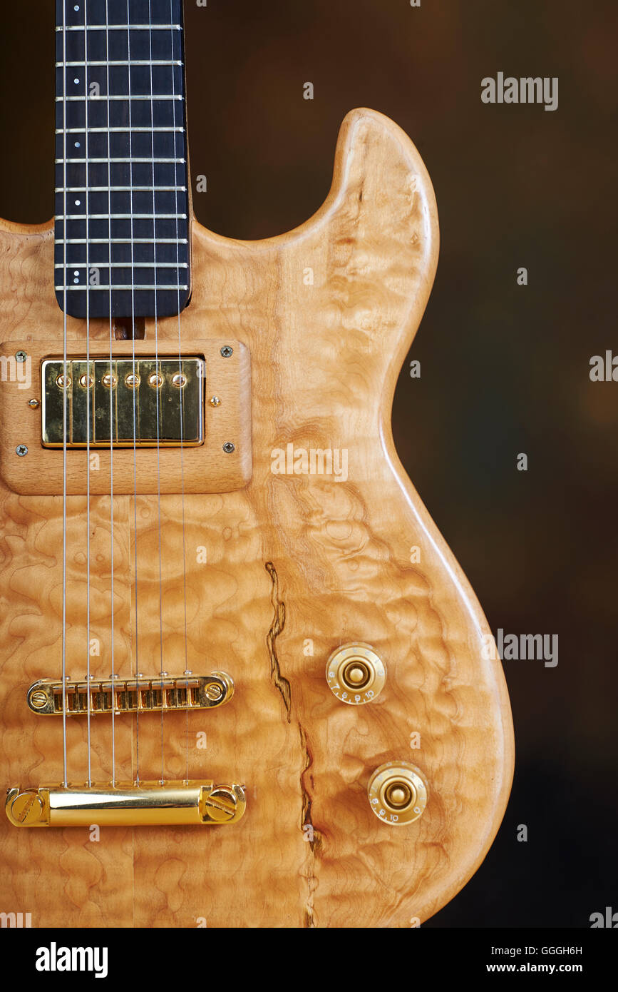 Guitar, wooden natural color with golden accessories Stock Photo - Alamy