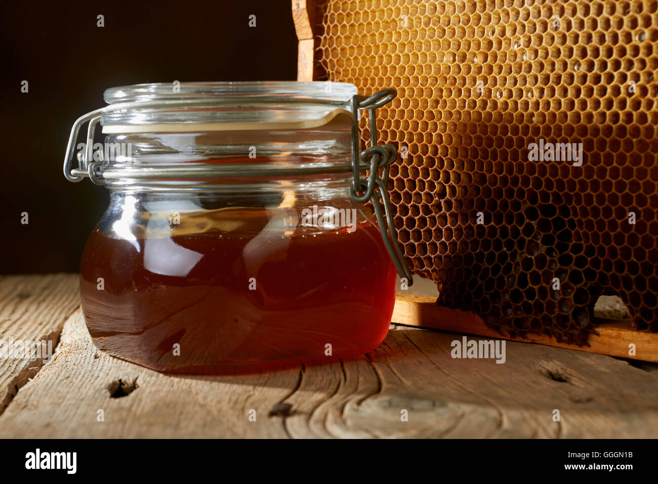 honeycomb on frame with fresh honey in a vase on wooden table Stock ...