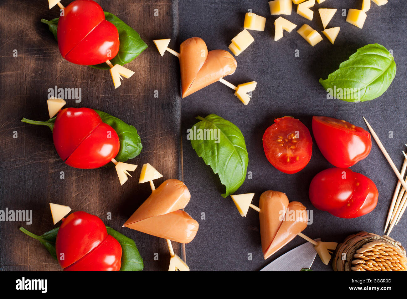 Marinated fillet with tomato and sausage heart shaped. Appetizer for a ...
