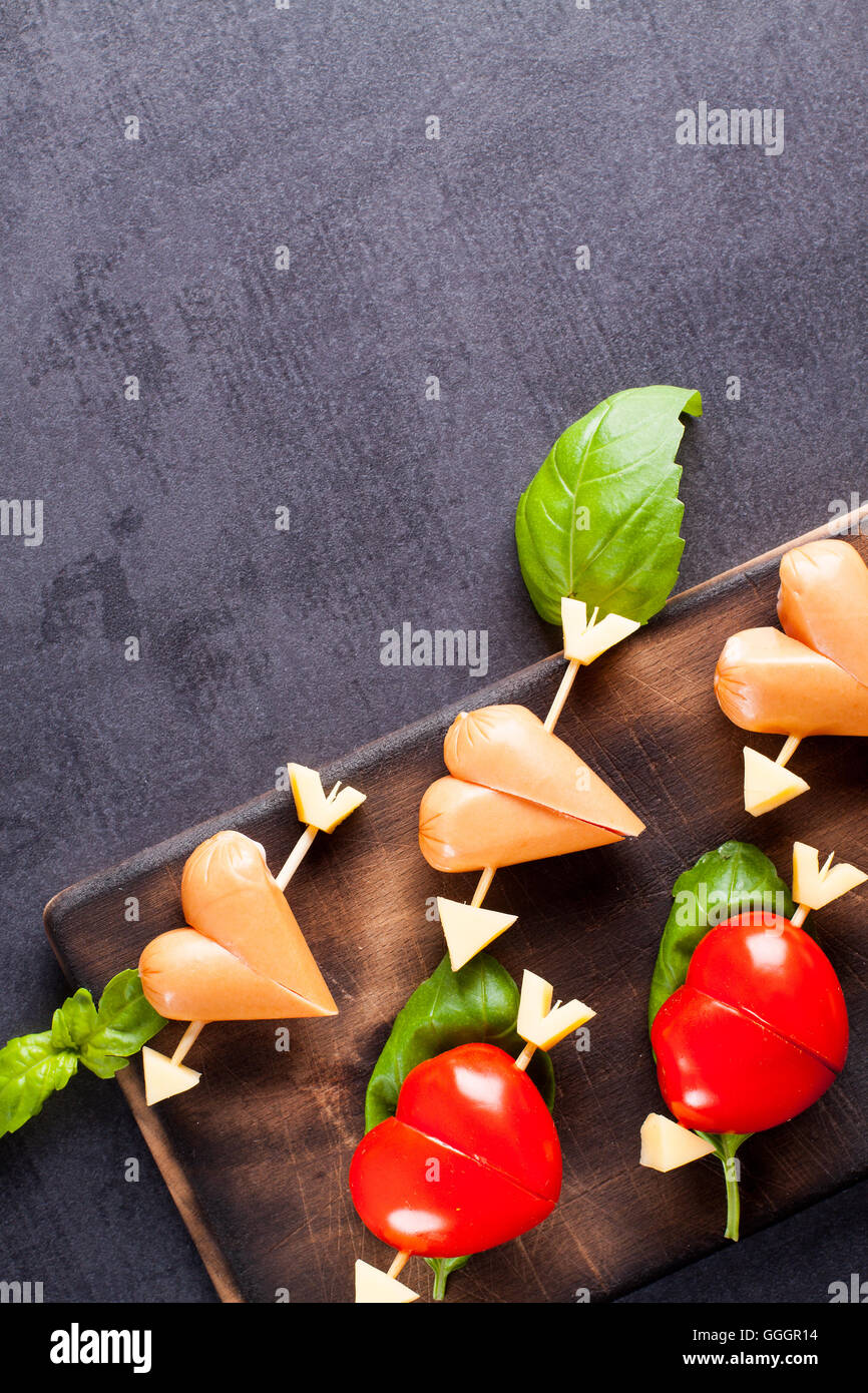 Marinated fillet with tomato and sausage heart shaped. Appetizer for a ...