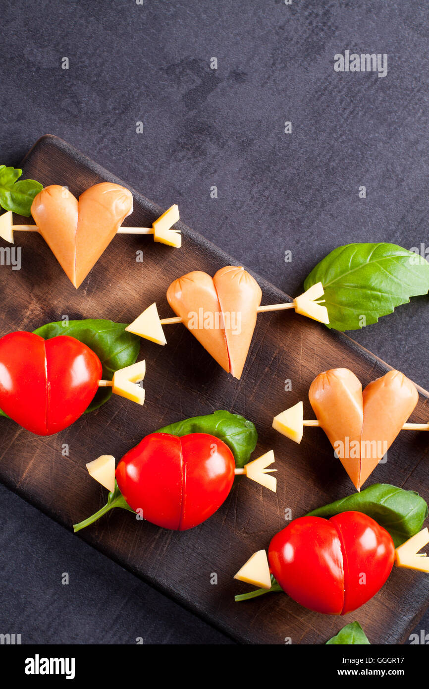 Marinated fillet with tomato and sausage heart shaped. Appetizer for a ...