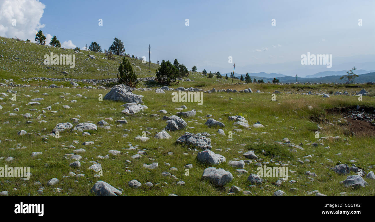 Green hill and a beautiful blue cloudy sky Stock Photo - Alamy