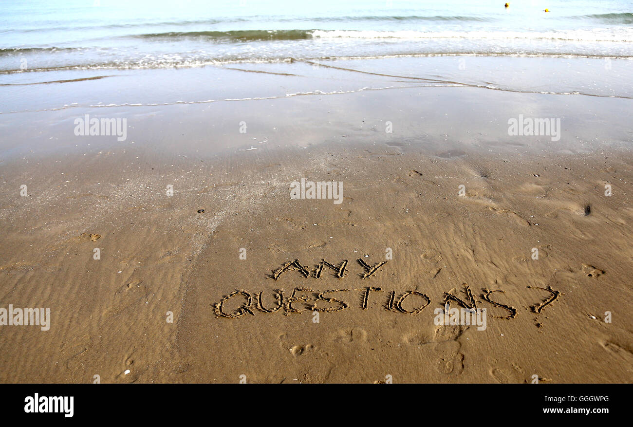 Any Questions great writing on the beach sand Stock Photo - Alamy