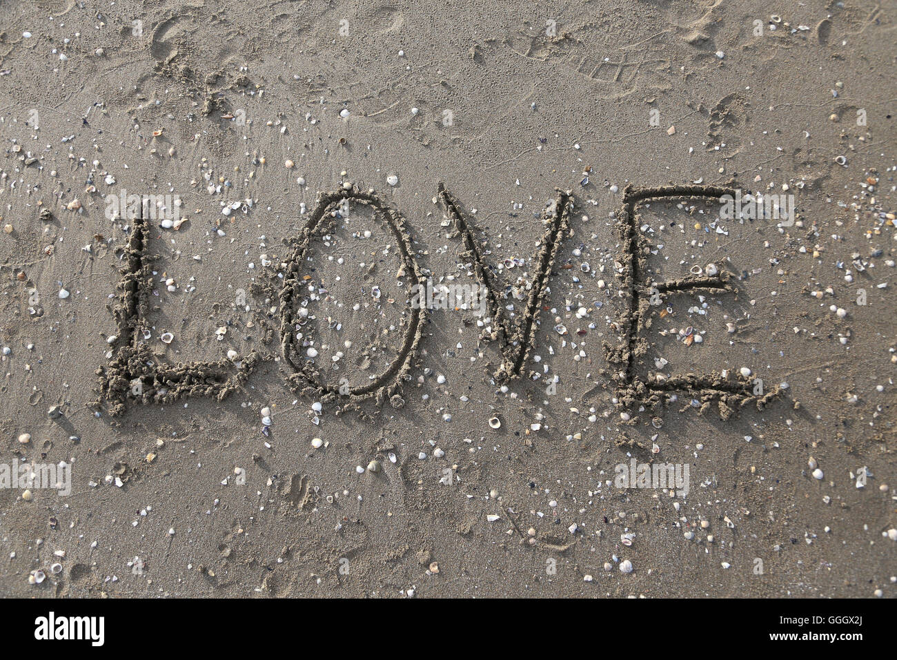 LOVE big written on the beach sand Stock Photo - Alamy