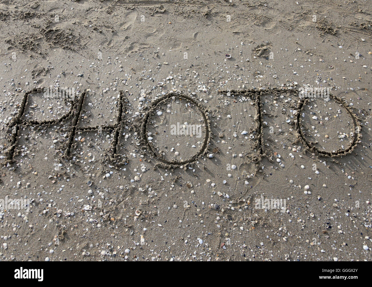 big PHOTO written on the beach sand Stock Photo - Alamy