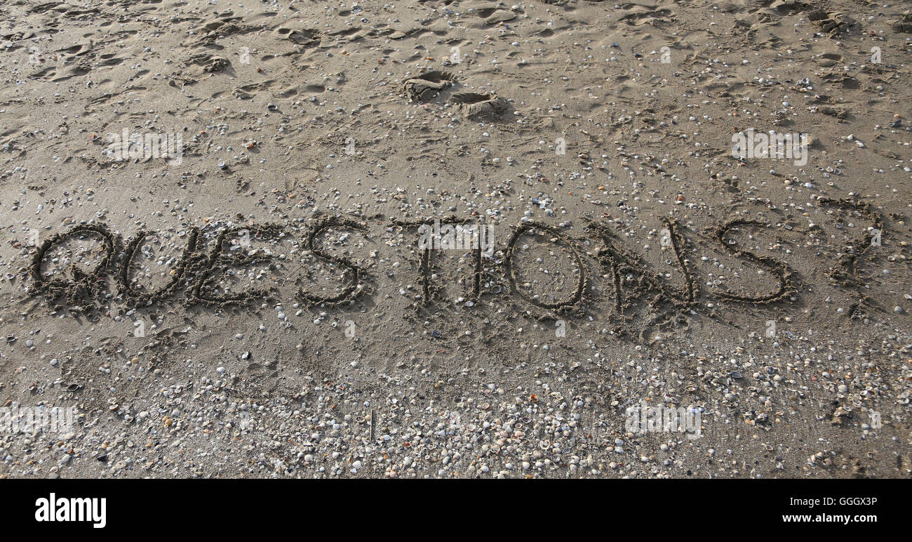 QUESTIONS written on the beach sand Stock Photo - Alamy