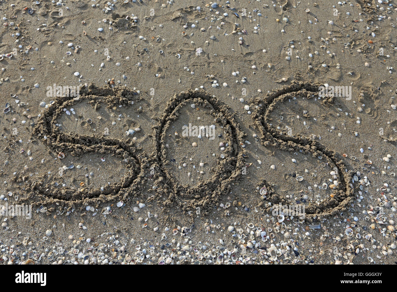 SOS big written on the beach sand Stock Photo - Alamy