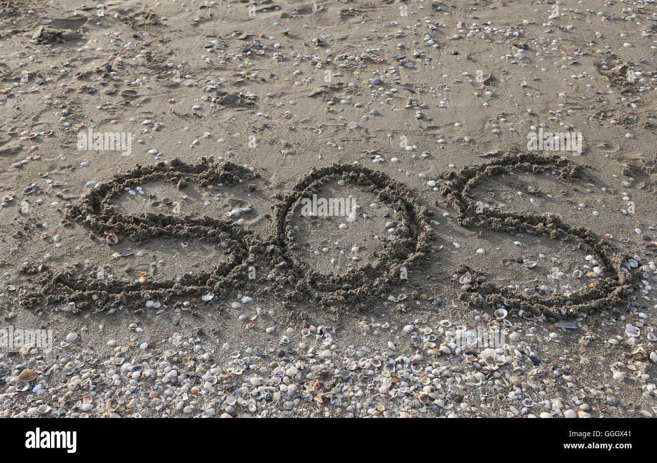 SOS big written on the beach by the sea Stock Photo - Alamy