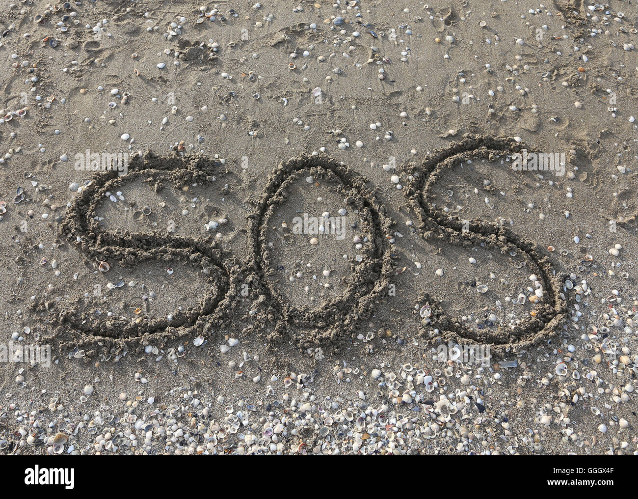 SOS big written on the beach sand Stock Photo - Alamy