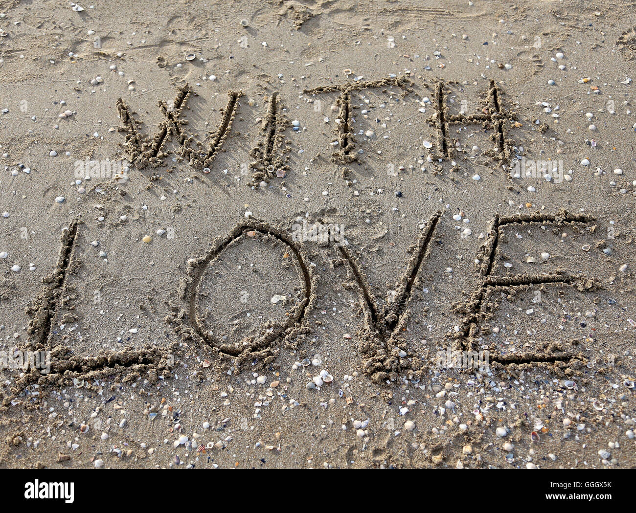 with love big written on the beach sand Stock Photo - Alamy