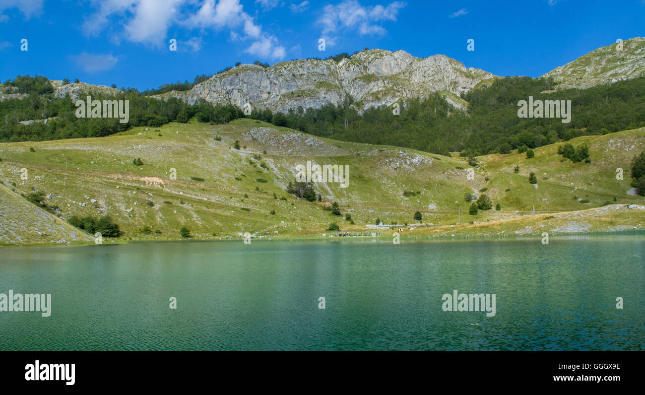 Lake surrounded by beautiful mountains Stock Photo - Alamy