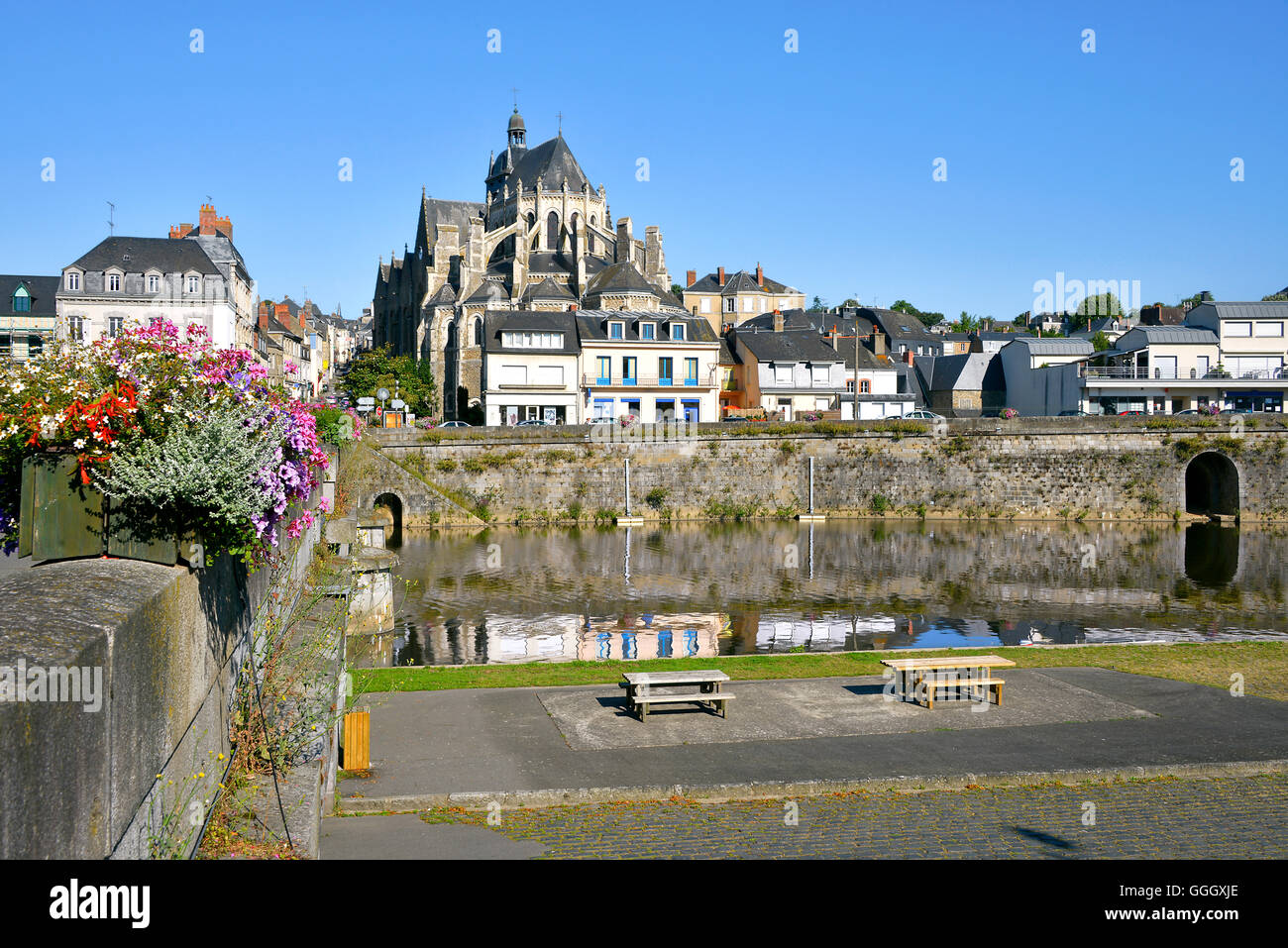 River in the town of Mayenne with Notre-Dame basilica, commune in the ...