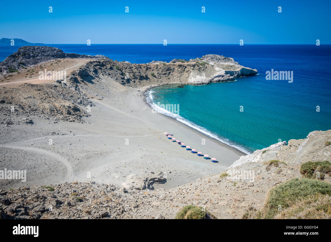 Agios Pavlos Beach in Crete island, Greece. Tourists relax and bath in crystal clear water of St ...