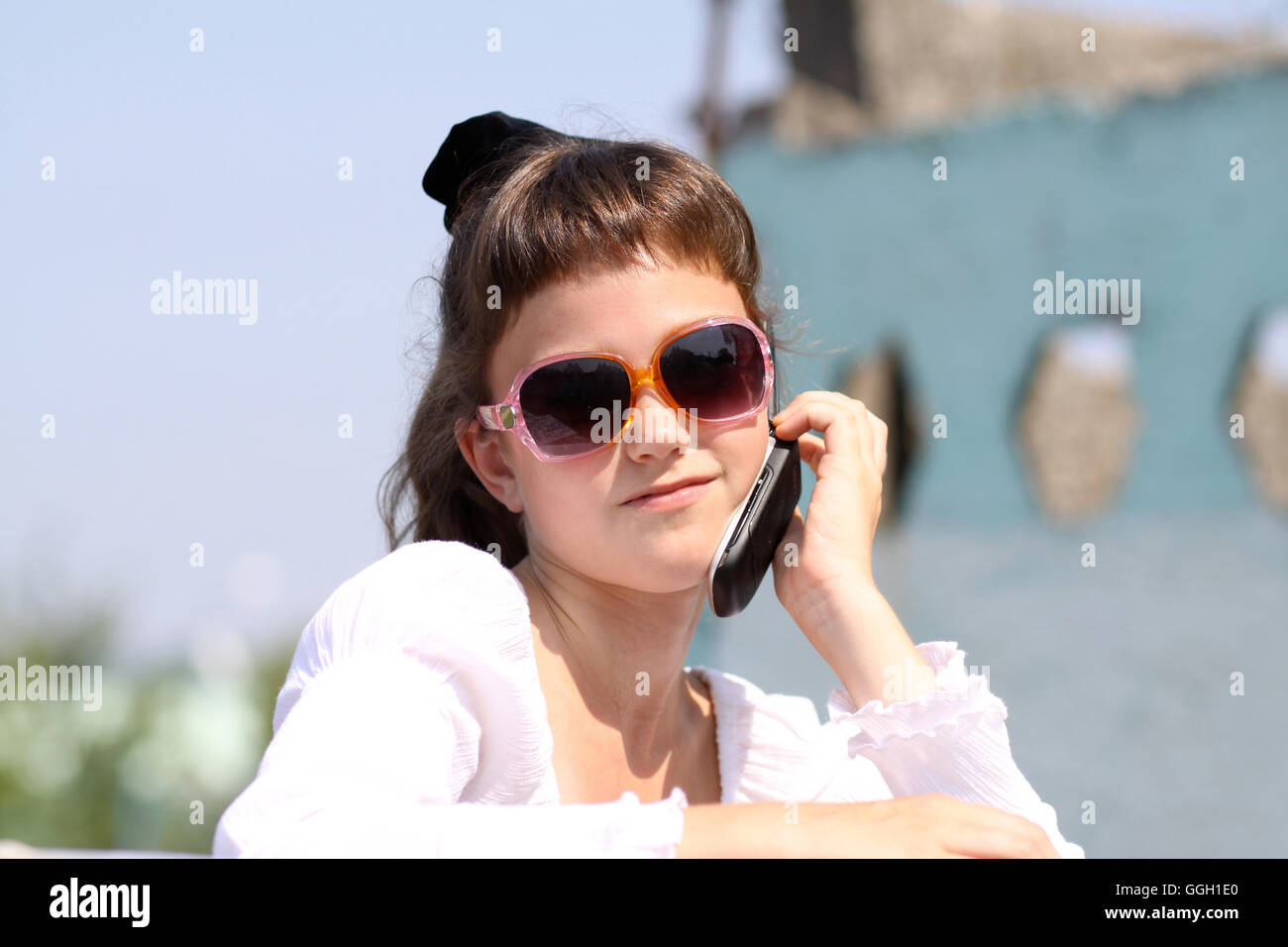 Beautiful little girl calling by phone Stock Photo - Alamy