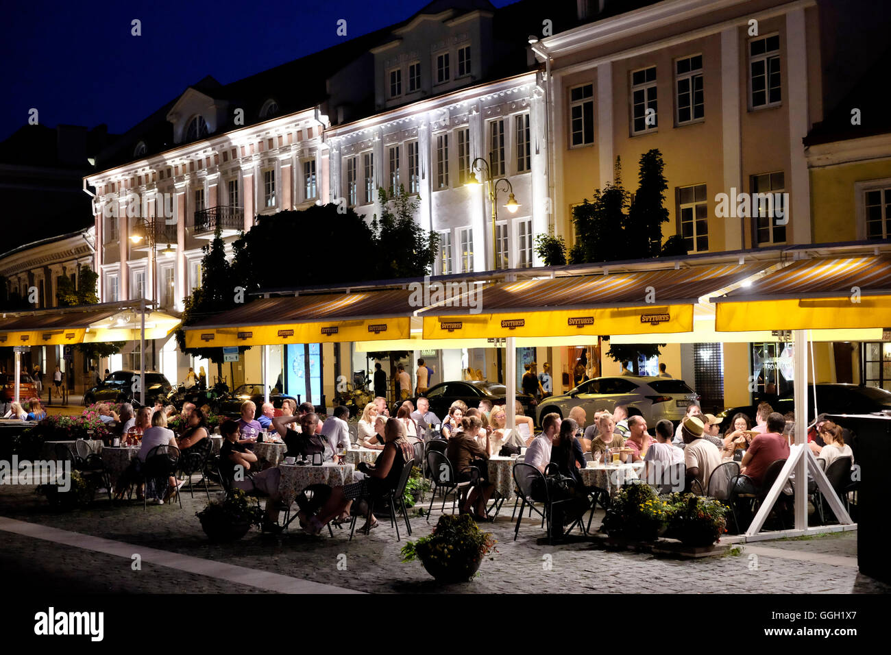 Customers dine outside at a restaurant in the old city of Vilnius in ...