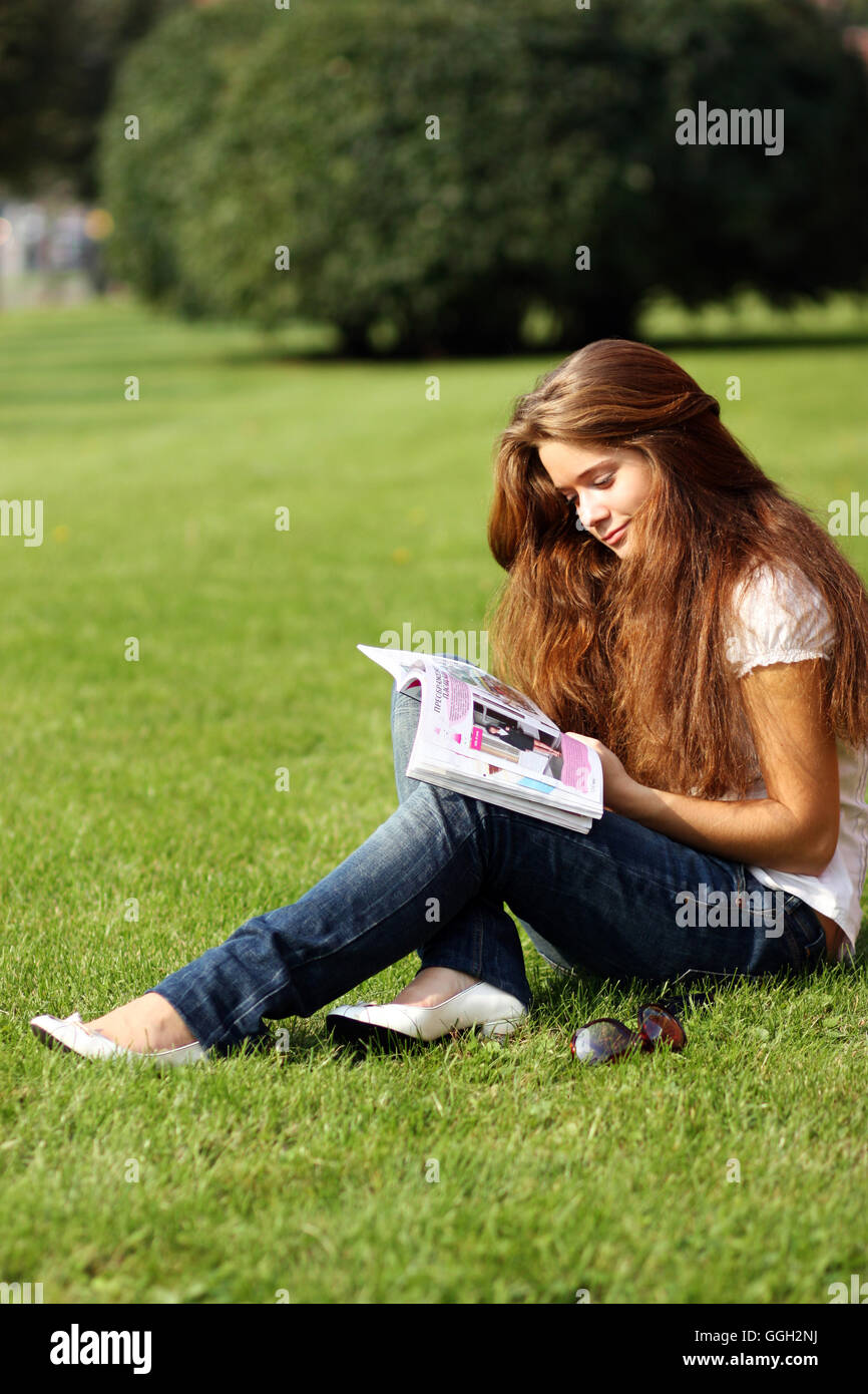 portrait of young beautiful woman reading magazine Stock Photo - Alamy