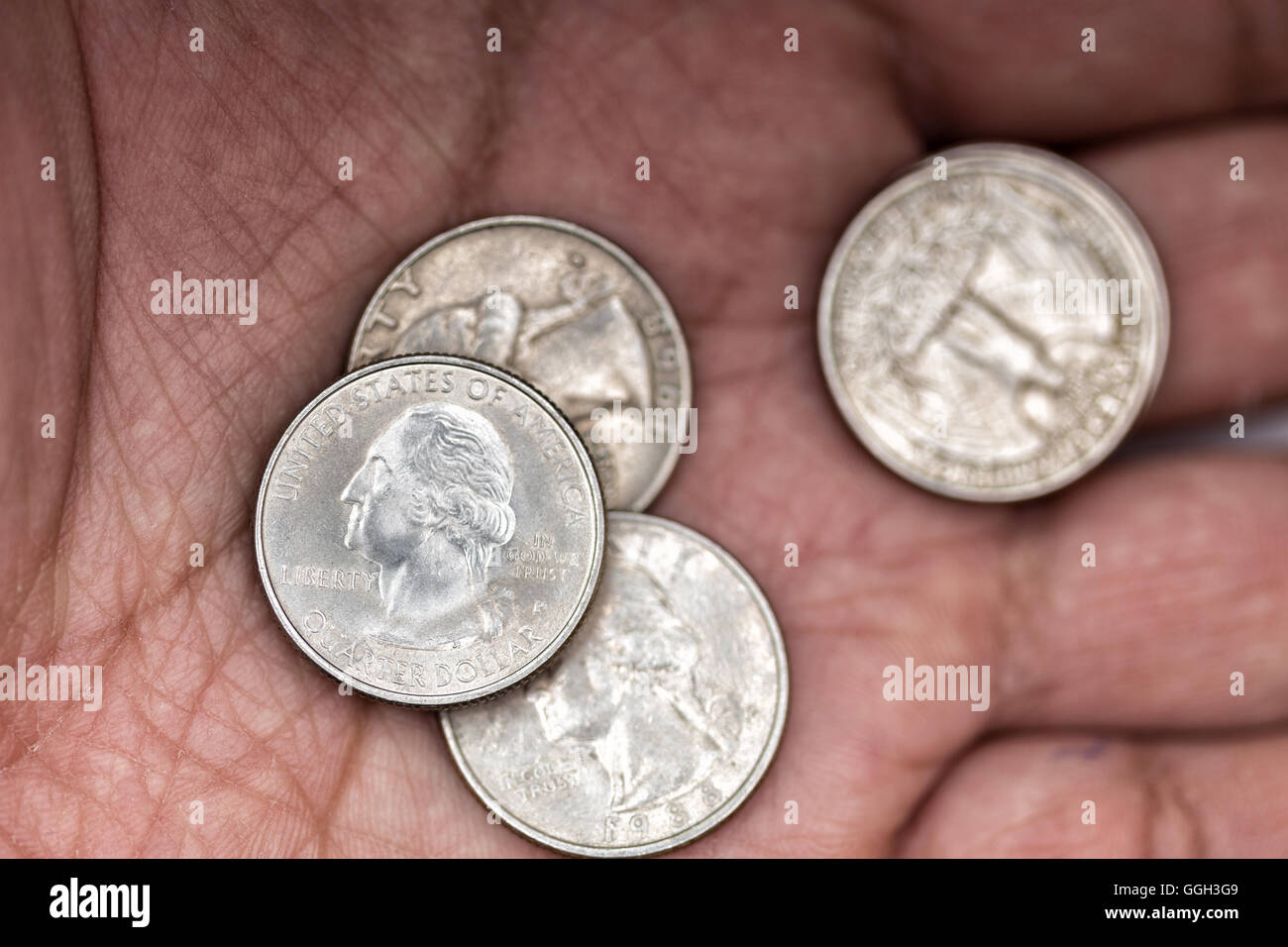 Hand holding quarters hi-res stock photography and images - Alamy