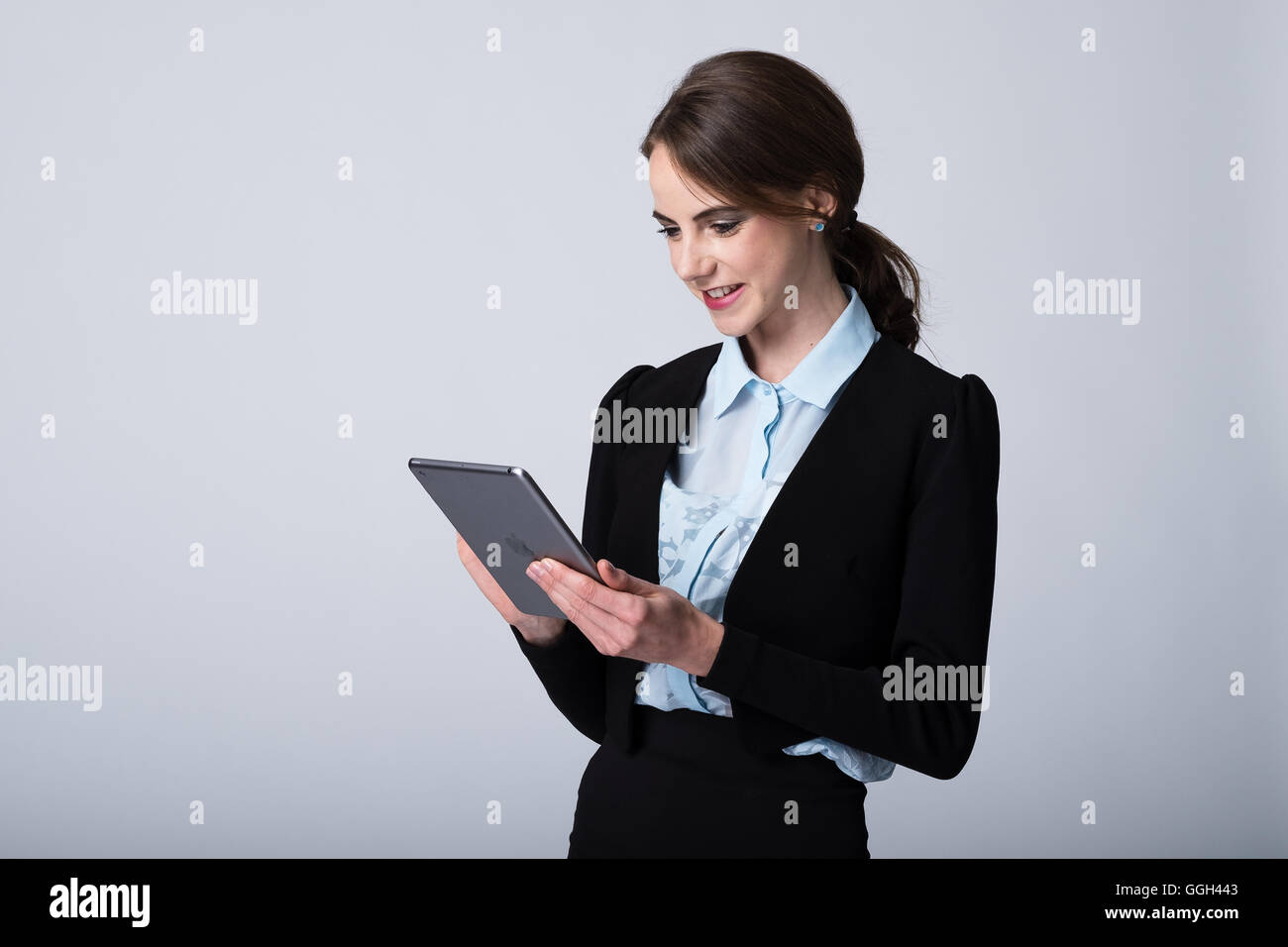 Confident business woman concentrates on performing a business task on ...