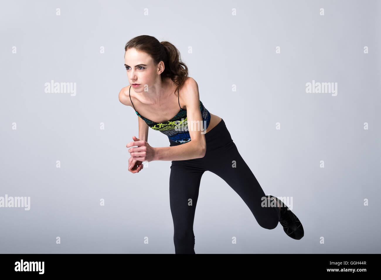 Very fit, serious, determined, young woman wearing training wear in ...