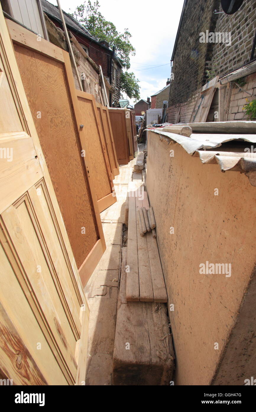 Freshly stripped vintage pine doors dry in the sun by a caustic ...