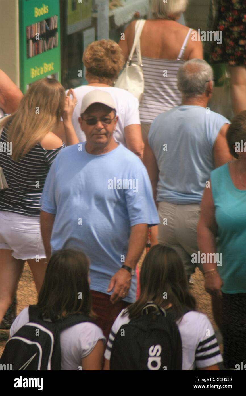 crowd of people walking through town centre Stock Photo - Alamy