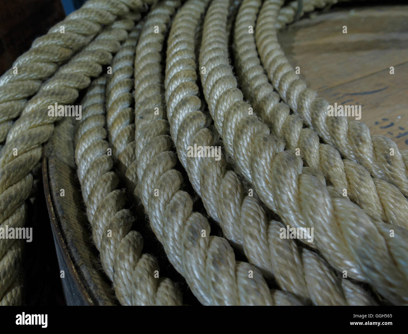 Strong marine rope coiled on a wooden barrel Stock Photo - Alamy