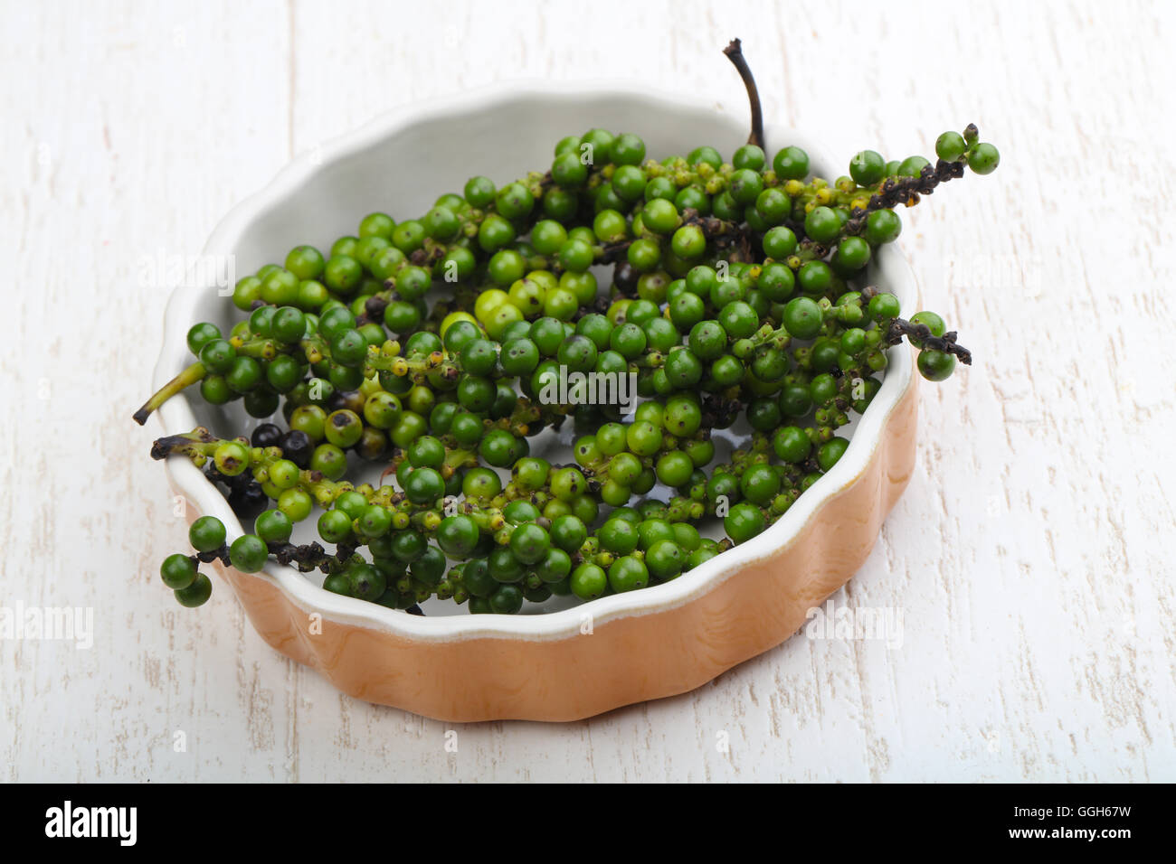 Green pepper corn on the branch in plate Stock Photo - Alamy