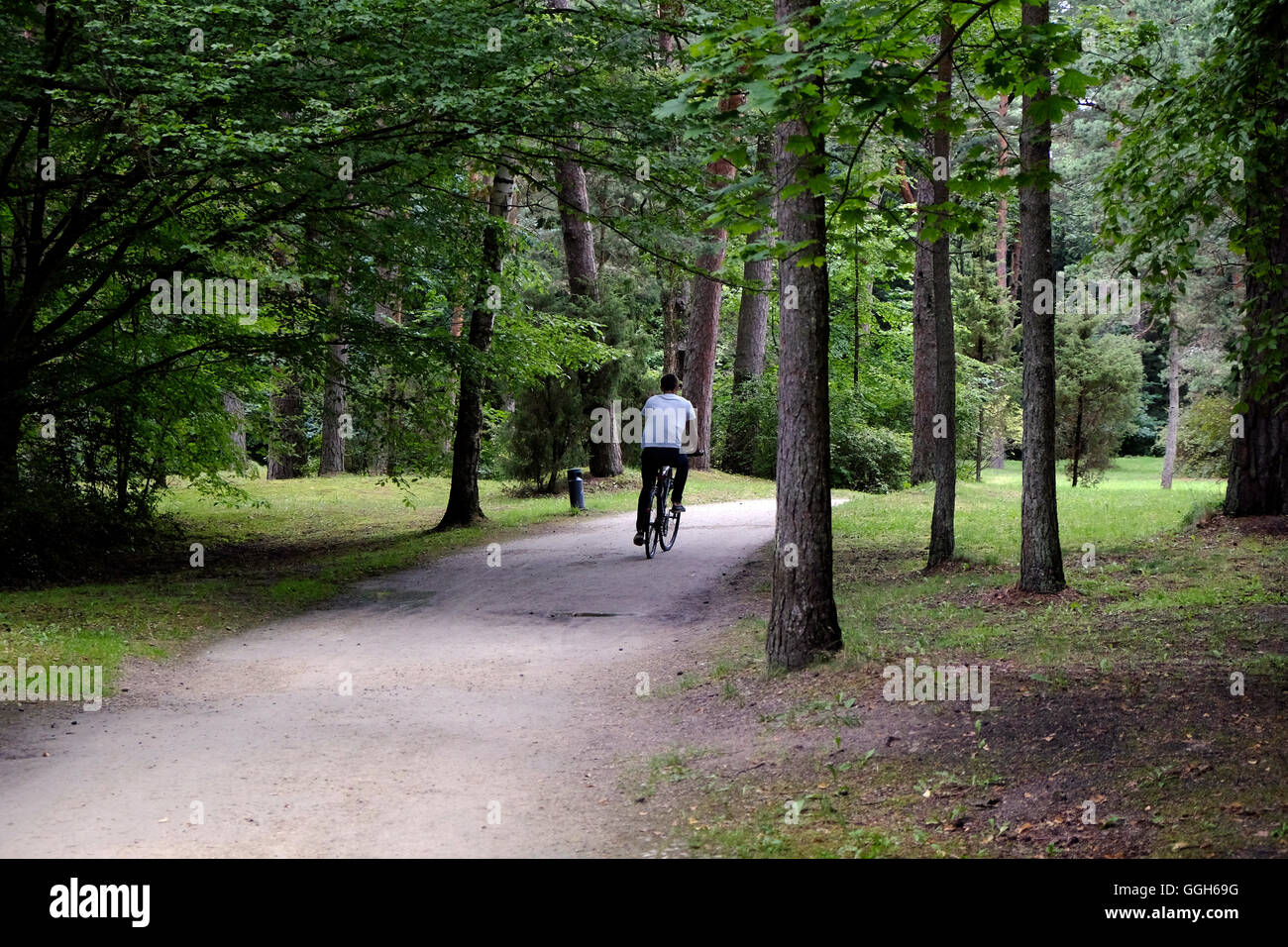Man cycling through Birute Park in the resort town of Palanga ...