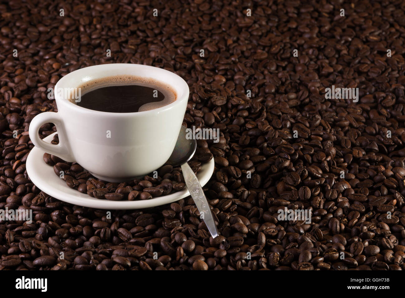 Cup of coffee on a background of coffee beans Stock Photo - Alamy