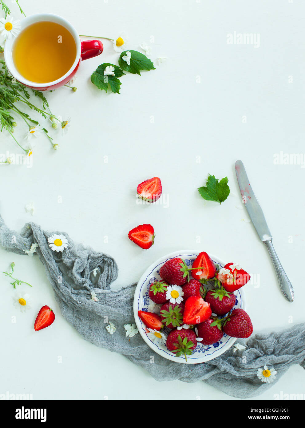 Fresh strawberry fruits, flowers, leaves on white wood table background ...