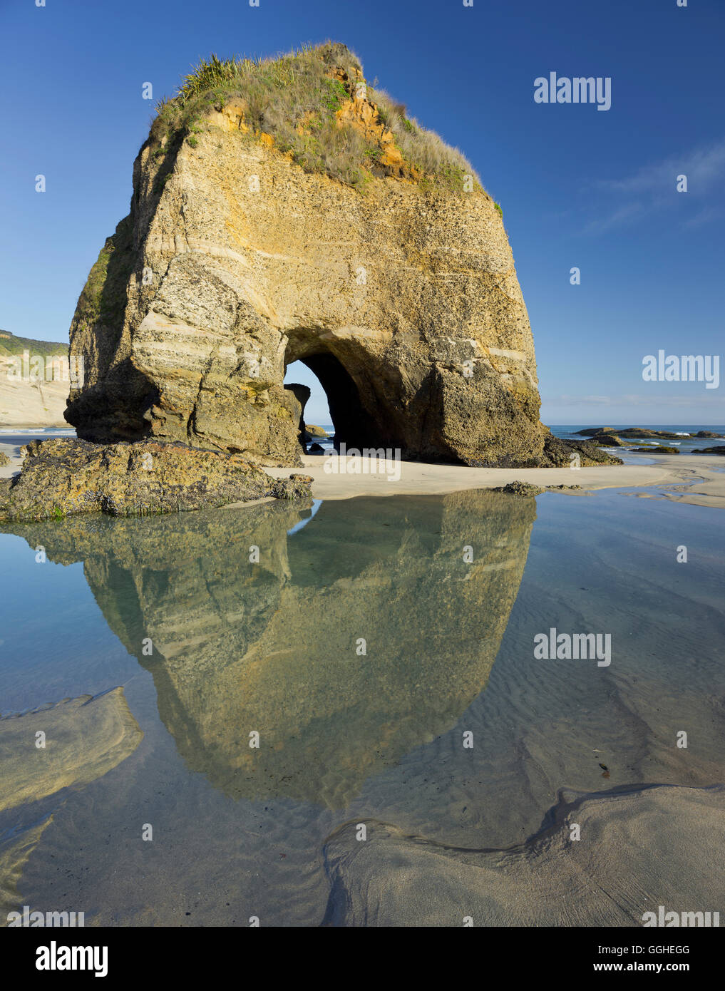 Rock arch on wharariki beach with hole hi-res stock photography and ...