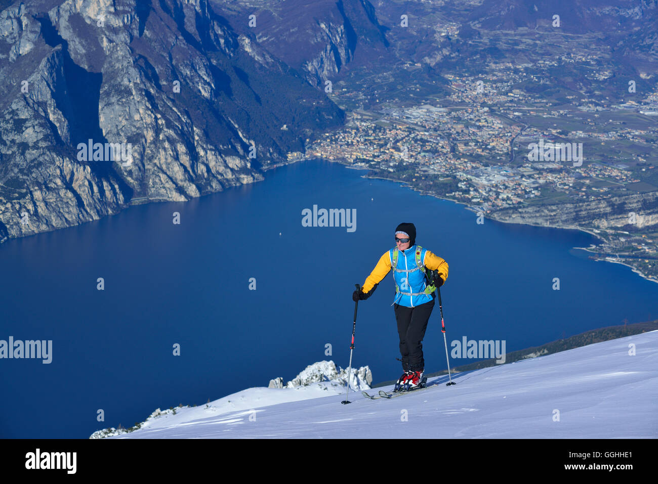 Female back-country skier ascending to Monte Baldo, lake Garda in ...