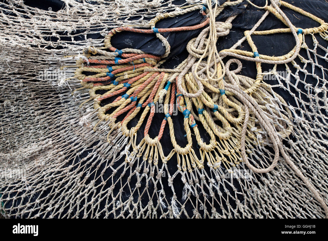 Fishing net tied with ropes Stock Photo - Alamy