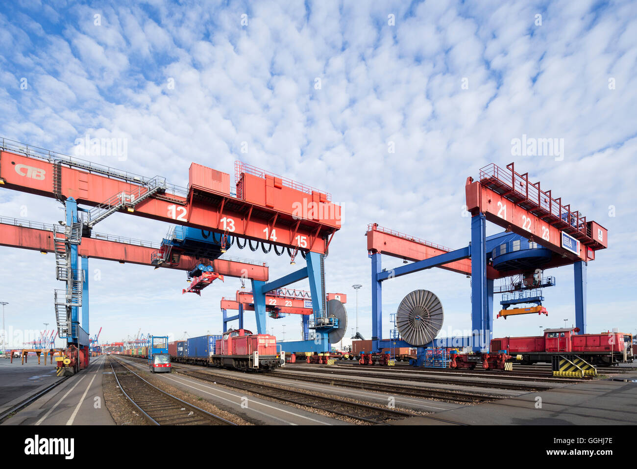 Freight train under a container bridge, Hamburg, Germany Stock Photo ...