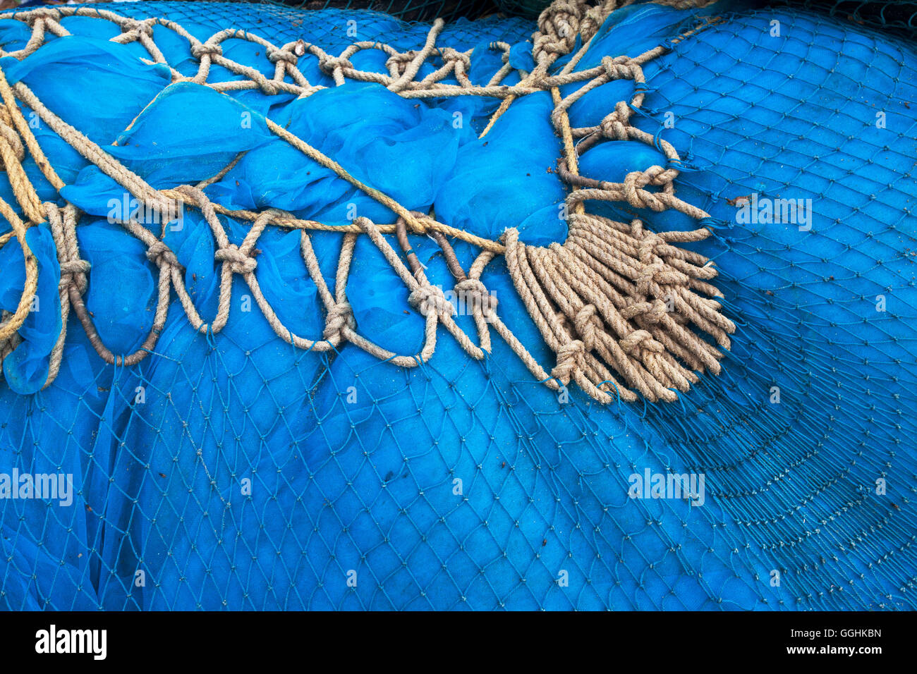 Fishing net tied with ropes Stock Photo - Alamy