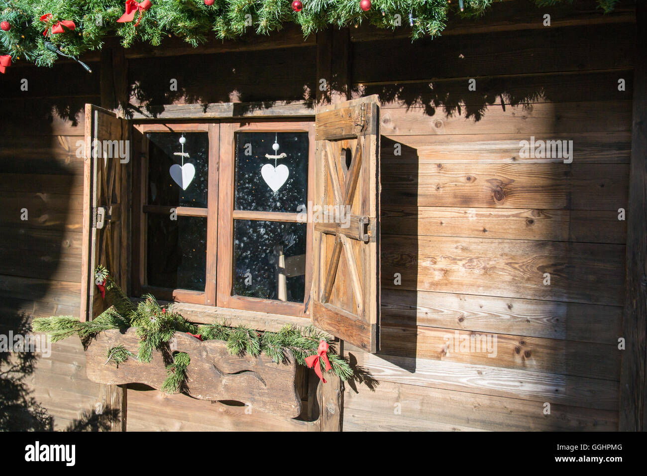 Wooden window of an alpine hut decked out for Christmas Stock Photo - Alamy